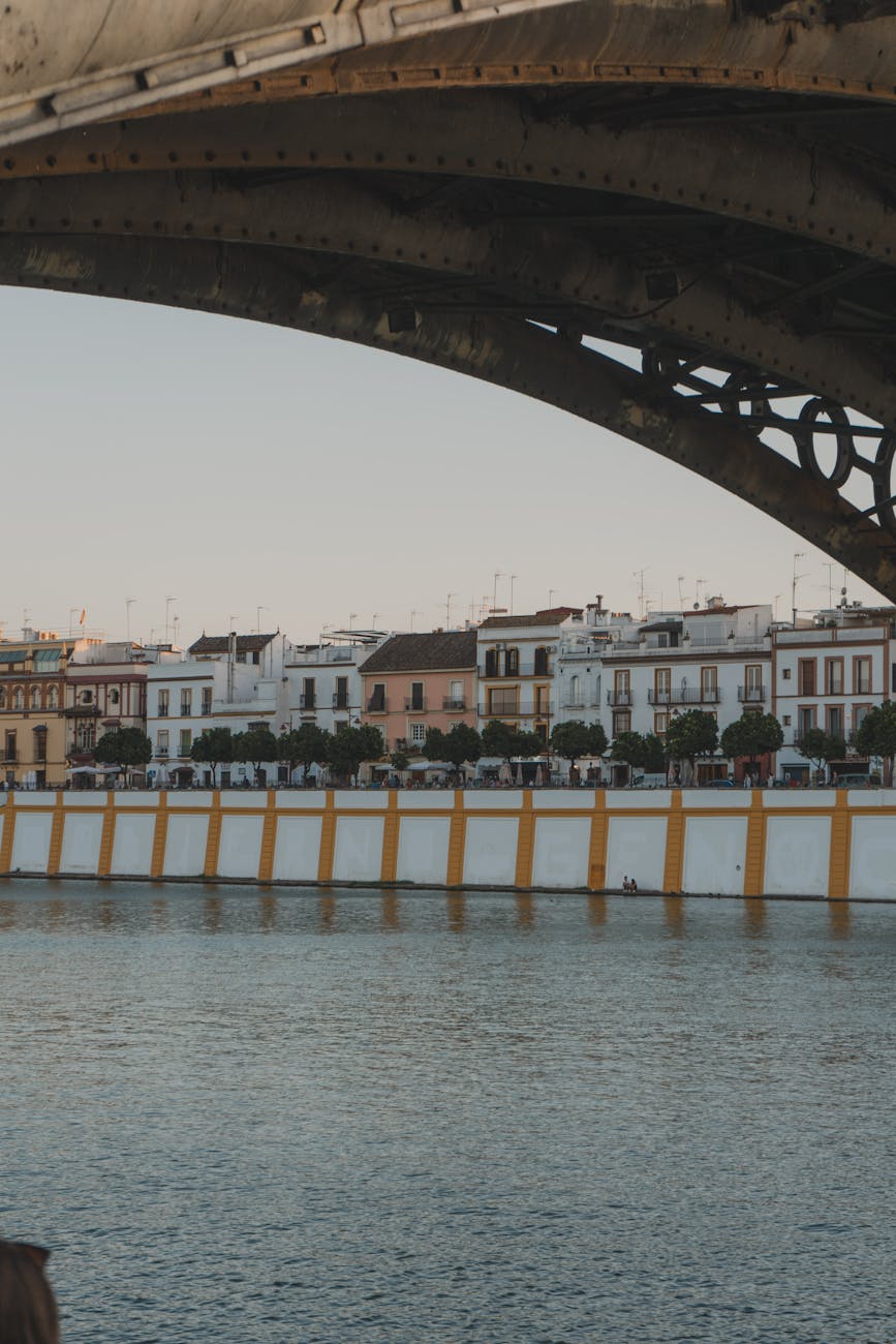Triana district seen from under a bridge at sunset in Seville