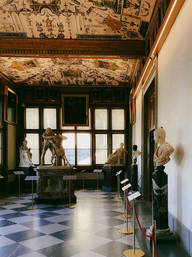 Renaissance marble sculptures displayed in a Florence art museum gallery