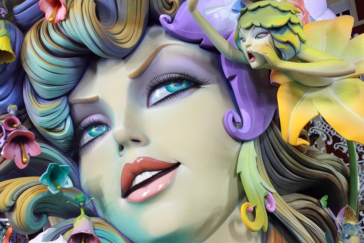 Colorful Las Fallas monument sculpture towering over a Valencia street