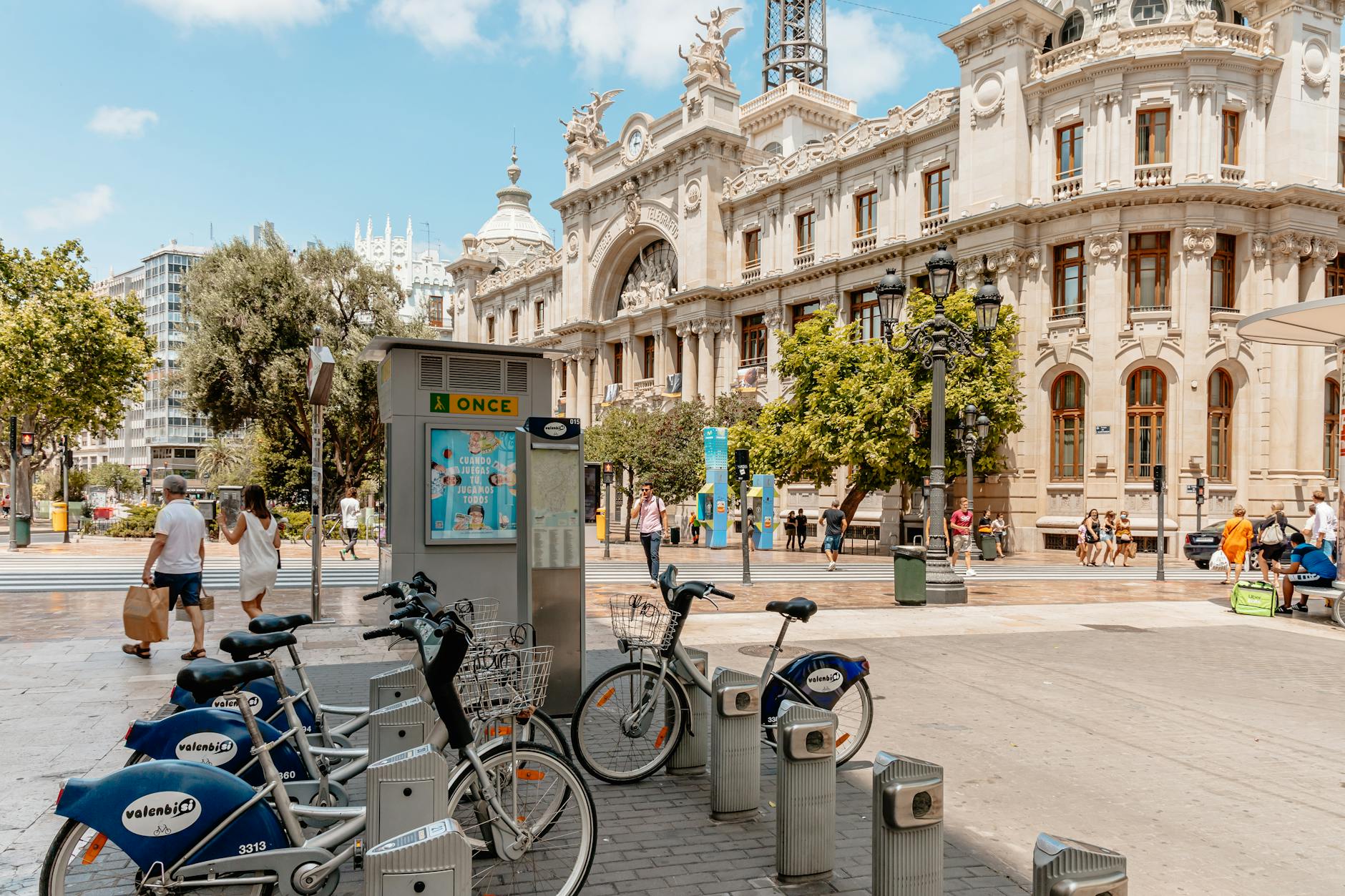 Bikes and people near the historical Plaza del Ayuntamiento in Valencia