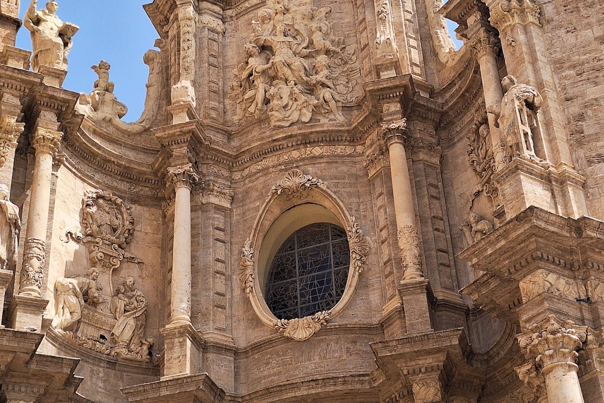 The ornate Baroque facade of Valencia Cathedral with intricate stone carvings