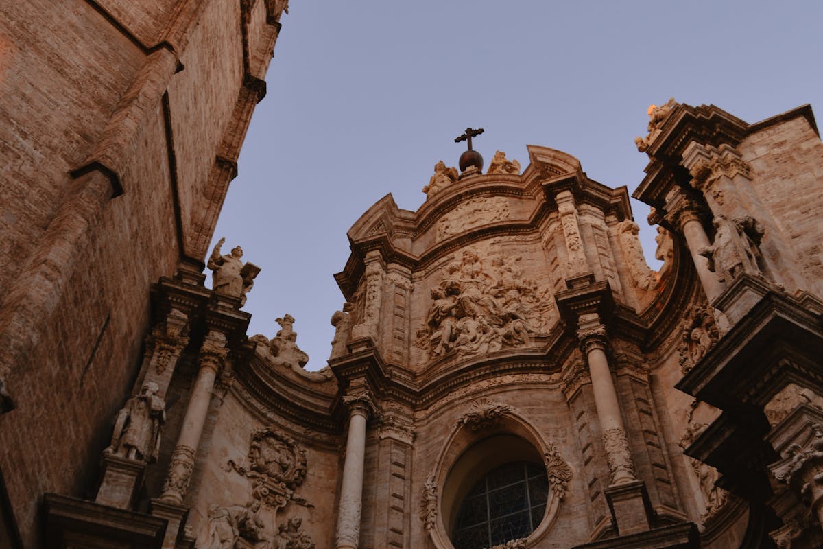 Valencia Cathedral with dramatic lighting at sunset highlighting baroque details