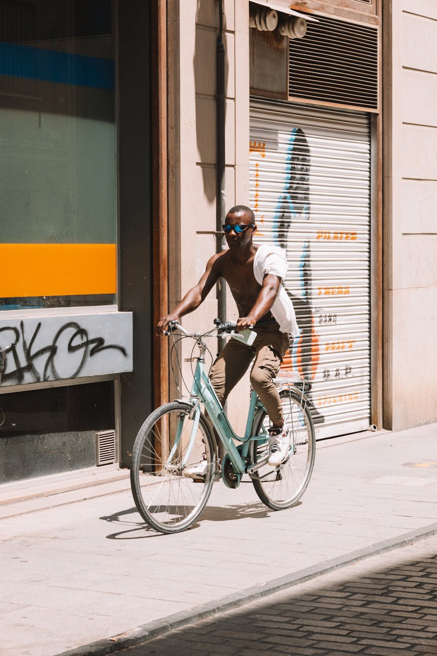 Cyclist enjoying a sunny day on the sidewalks of Valencia, Spain