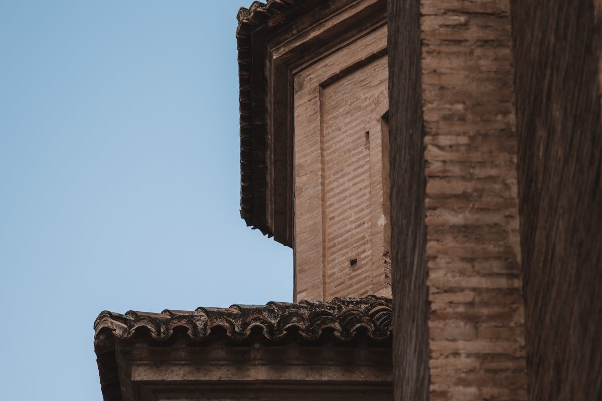 Brick gothic tower against clear blue sky in Valencia Spain