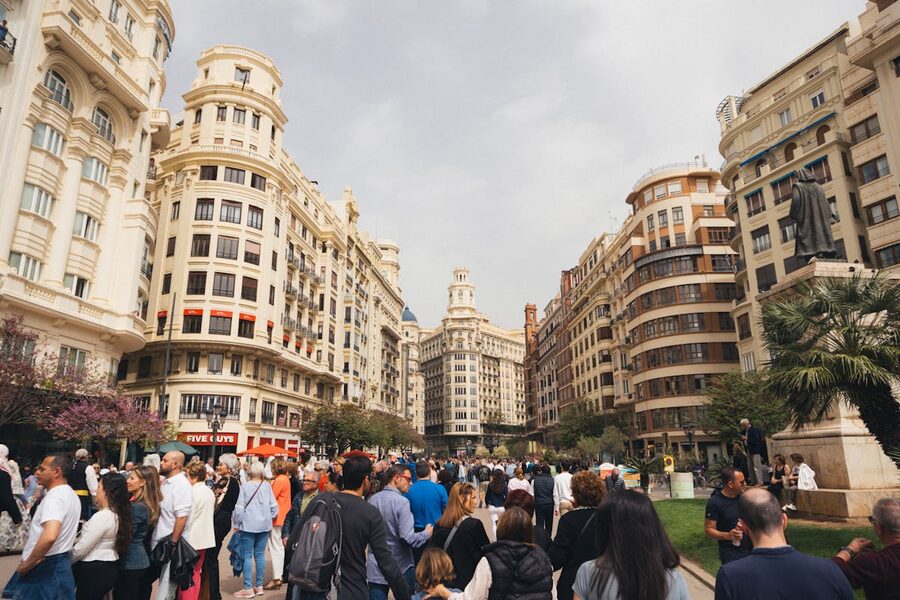 A lively plaza in Valencia Spain with historic buildings and people