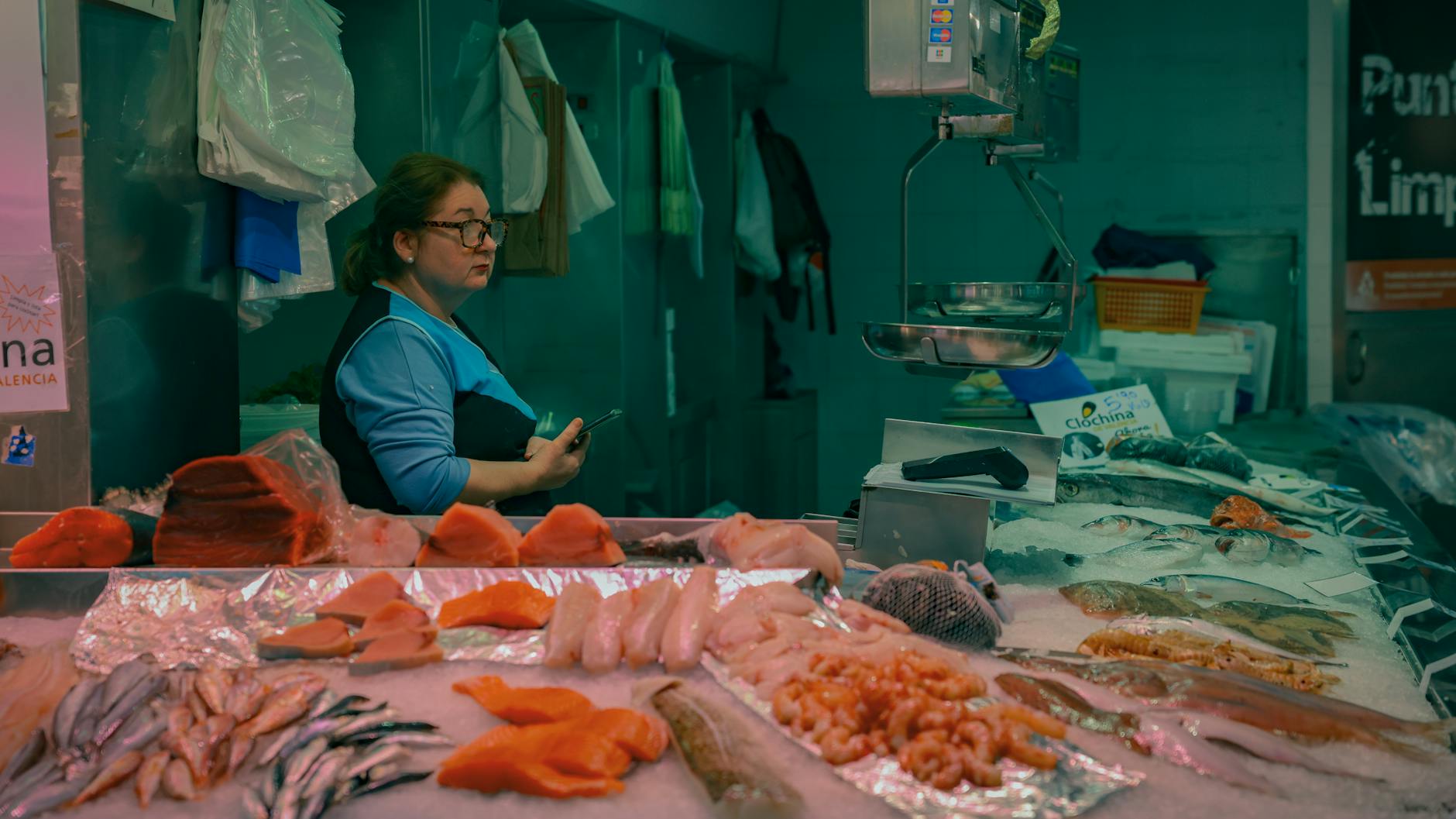 Vendor at Valencia market with fresh fish and seafood