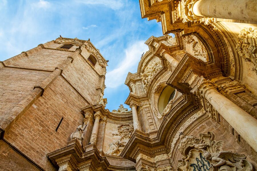 Gothic bell tower El Miguelete rising above Valencia Cathedral against a clear sky