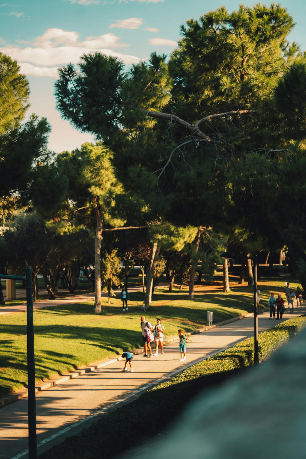 Families walking through Turia Gardens in Valencia on a sunny day