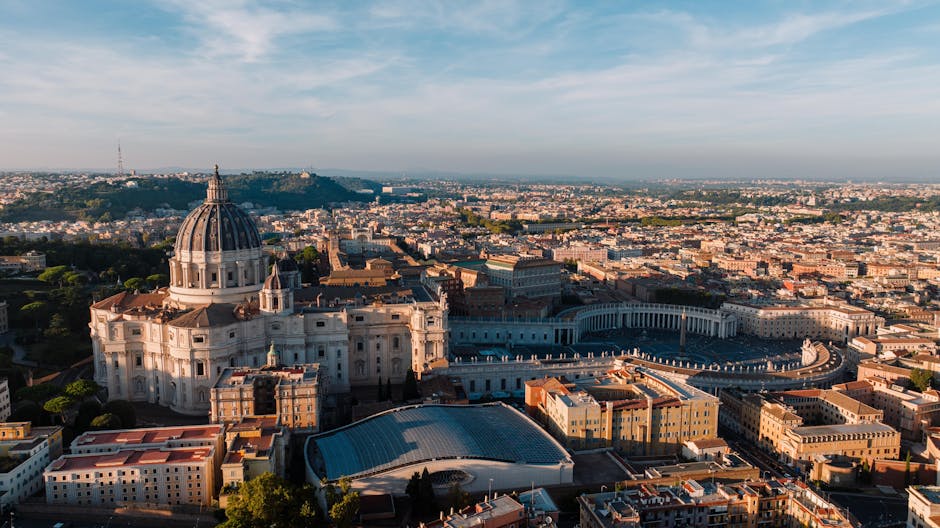 Aerial view of St Peters Basilica dome and Vatican City in Rome during golden hour