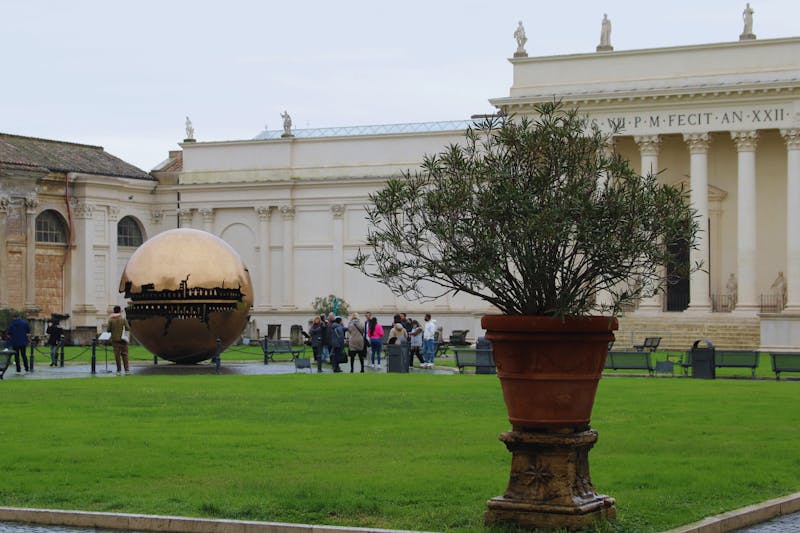 The golden Sphere Within Sphere sculpture by Arnaldo Pomodoro in the Vatican Museums Pine Cone Courtyard