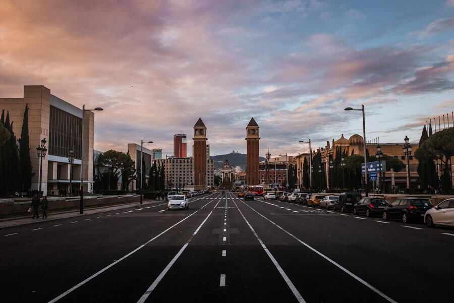 Wide street view of the Venetian Towers at Placa Espanya in Barcelona at sunset