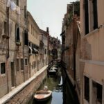 A picturesque canal in Venice with historic buildings and a small bridge