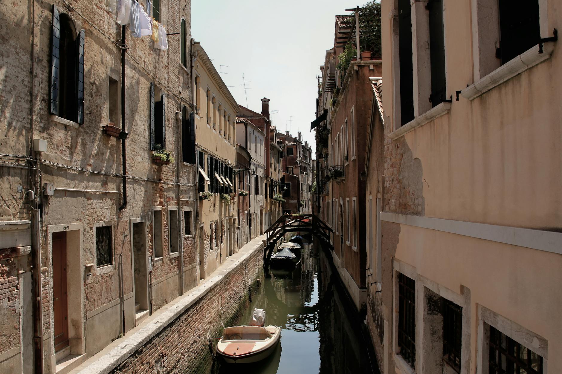 A picturesque canal in Venice with historic buildings and a small bridge