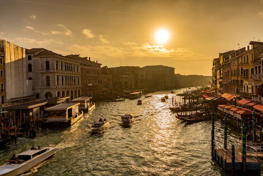 The Grand Canal in Venice bathed in golden sunset light with historic palaces on both sides