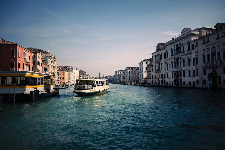 A vaporetto water bus traveling along the Grand Canal in Venice on a sunny day