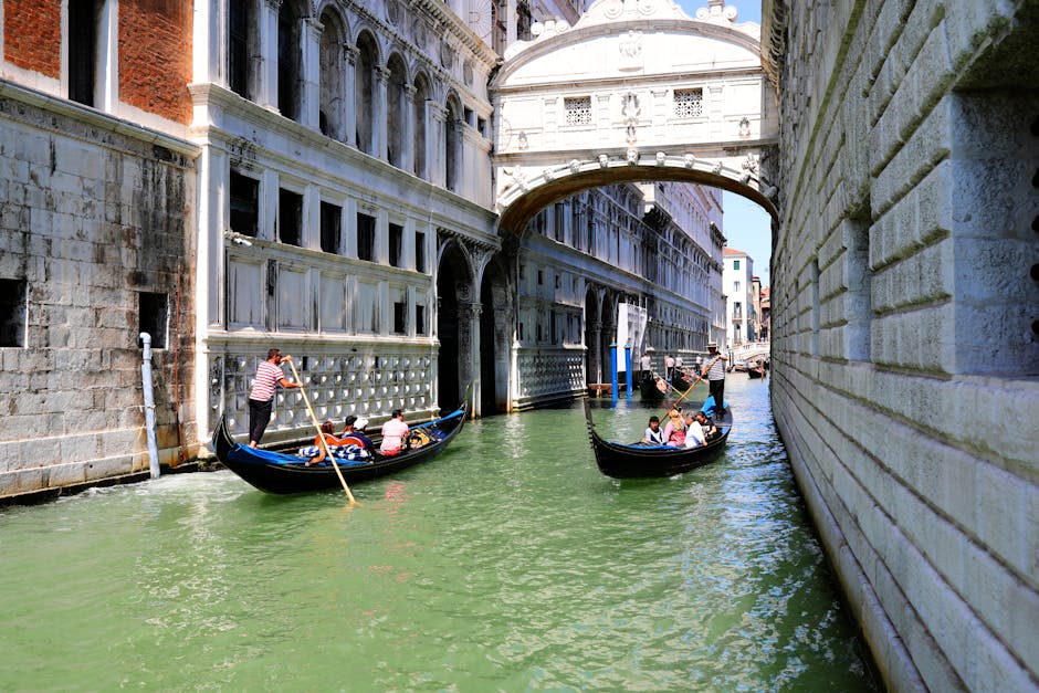 Gondolas on a canal near the Bridge of Sighs in Venice, Italy with stone bridges and historic buildings