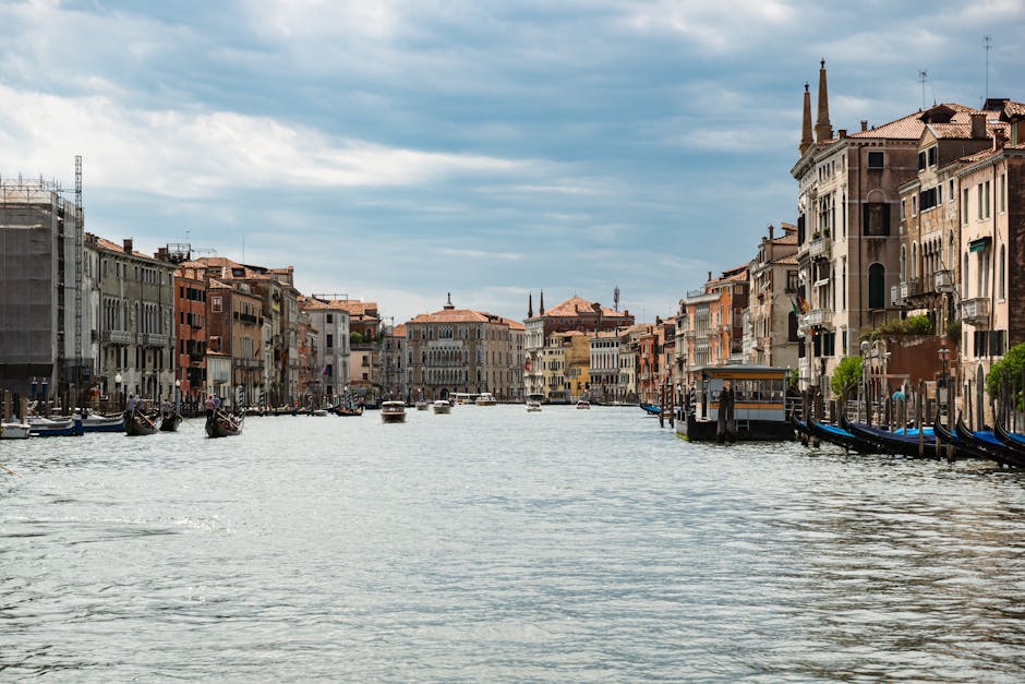 Panoramic view of the Grand Canal in Venice showing gondolas, water taxis, and historic palazzos lining both sides