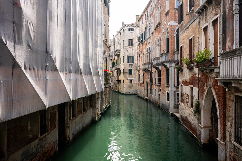 A picturesque Venice canal lined with historic buildings and moored boats in the historic district