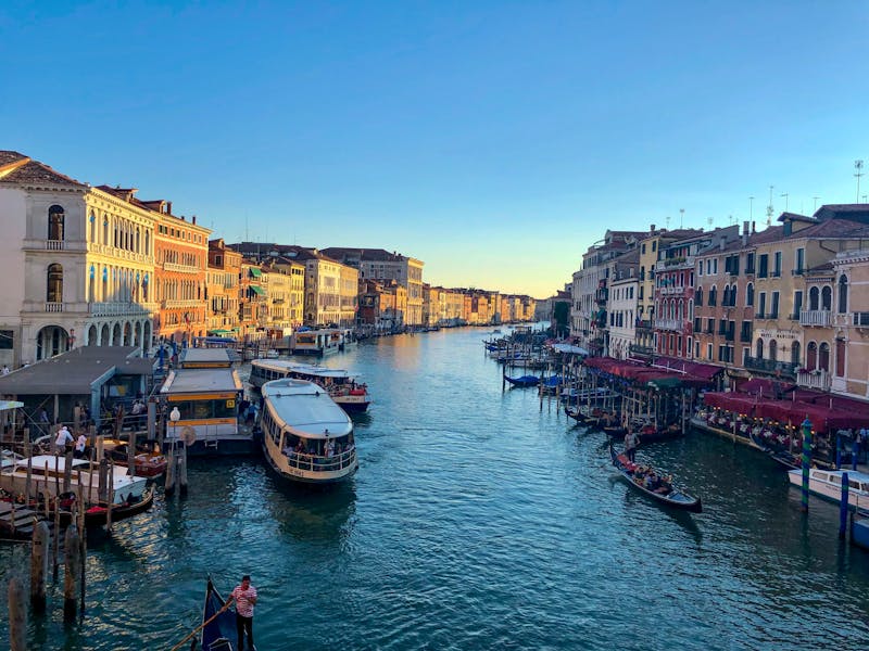 Sunset view of Venice Grand Canal with colorful buildings and gondolas