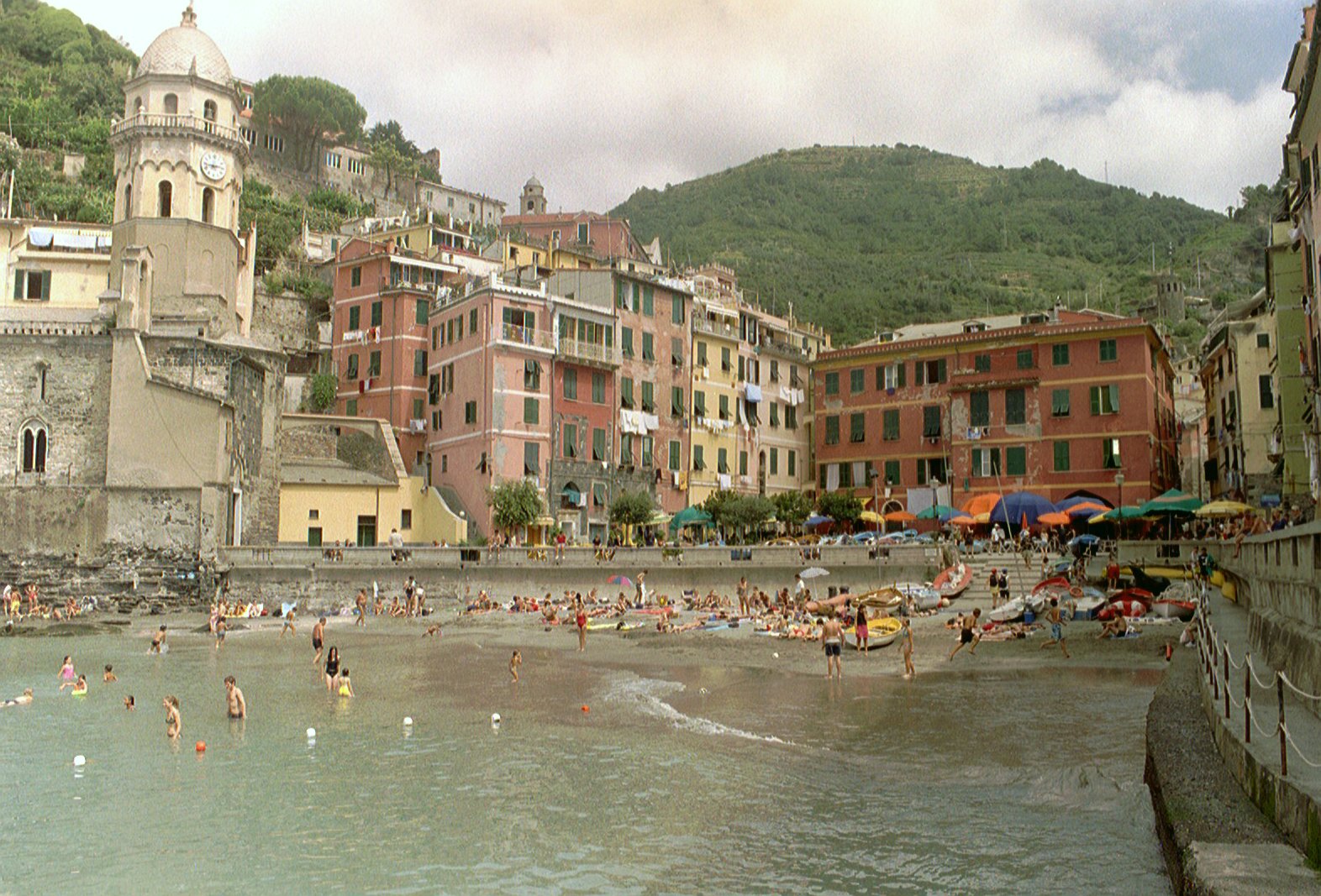 View of Vernazza harbor and the compact village with its church tower rising above colorful houses
