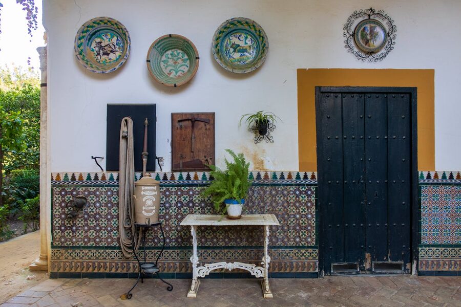 A traditional Andalusian patio with mosaic tiles and decorative ceramic elements
