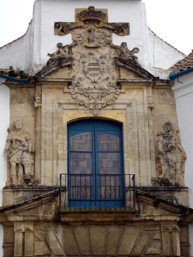 One of the twelve courtyards inside Viana Palace in Cordoba with a central fountain surrounded by plants