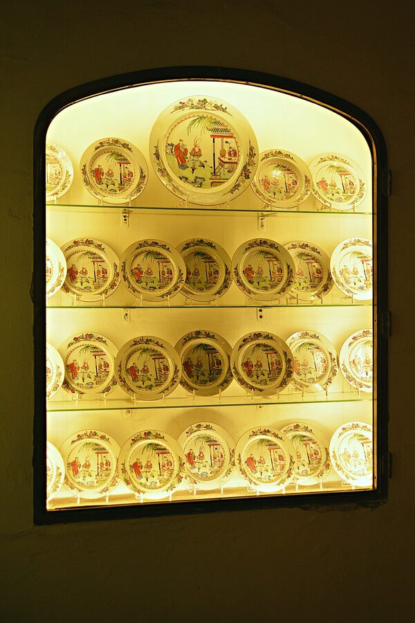 An ornate stone fountain in a courtyard at Viana Palace in Cordoba surrounded by greenery and flowers