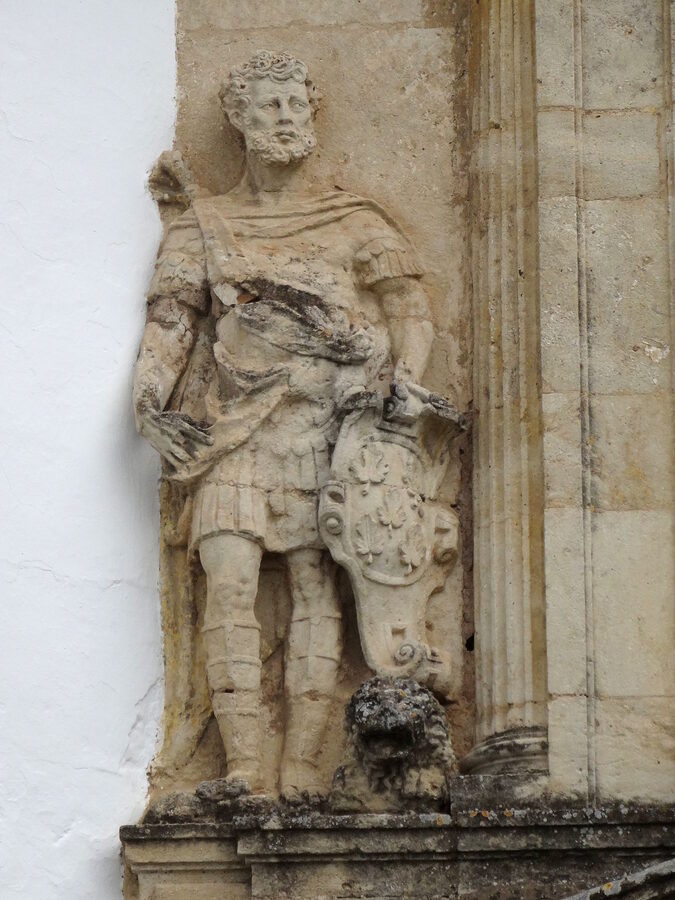 A garden courtyard at Viana Palace in Cordoba with orange trees and flowering plants