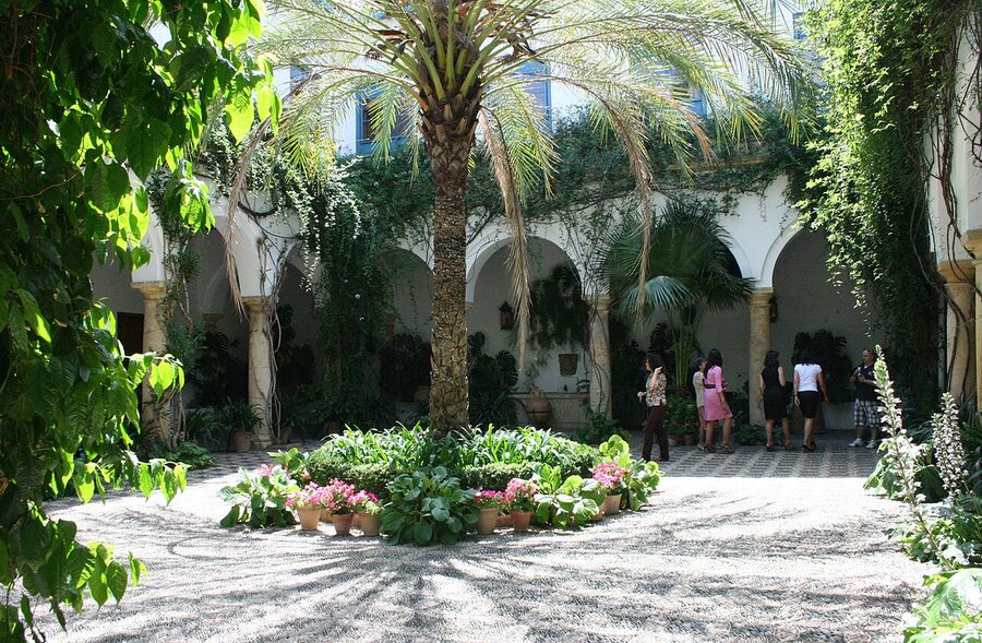 The reception courtyard of Viana Palace in Cordoba with arched stone colonnade and central garden