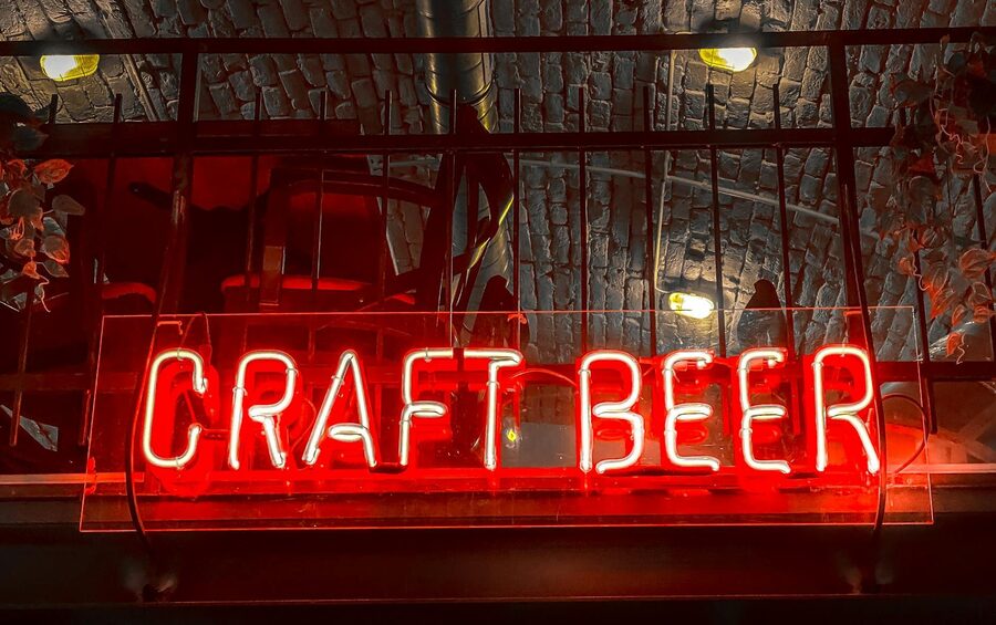 Vibrant neon craft beer sign at a bar in Budapest