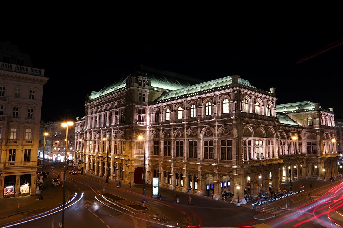 Vienna State Opera building illuminated at night with light trails