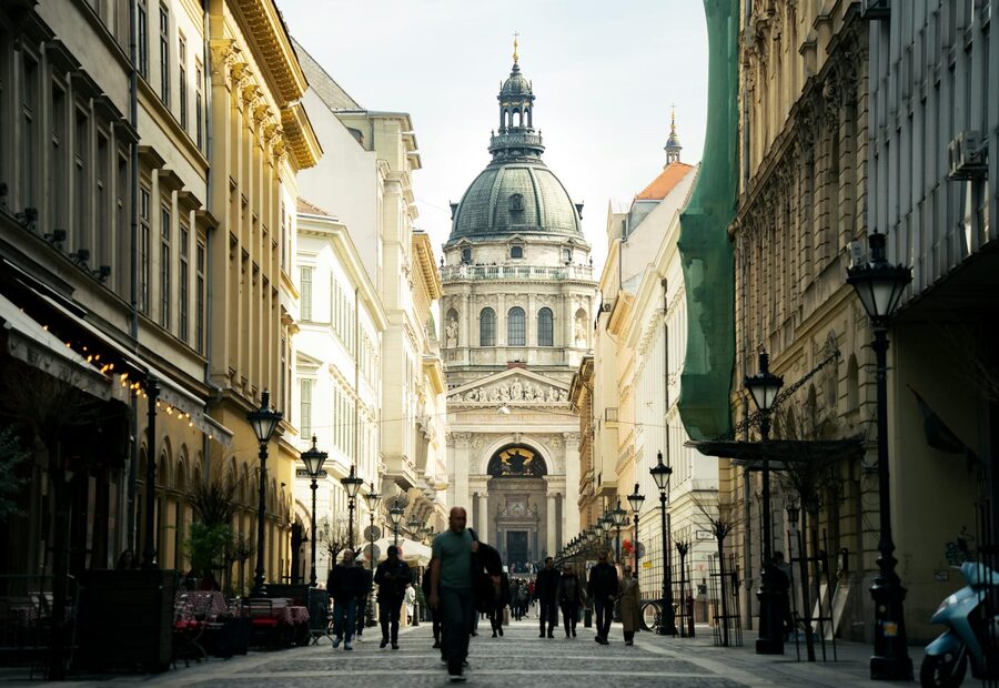 View of Saint Stephen's Basilica with pedestrians on a bustling street