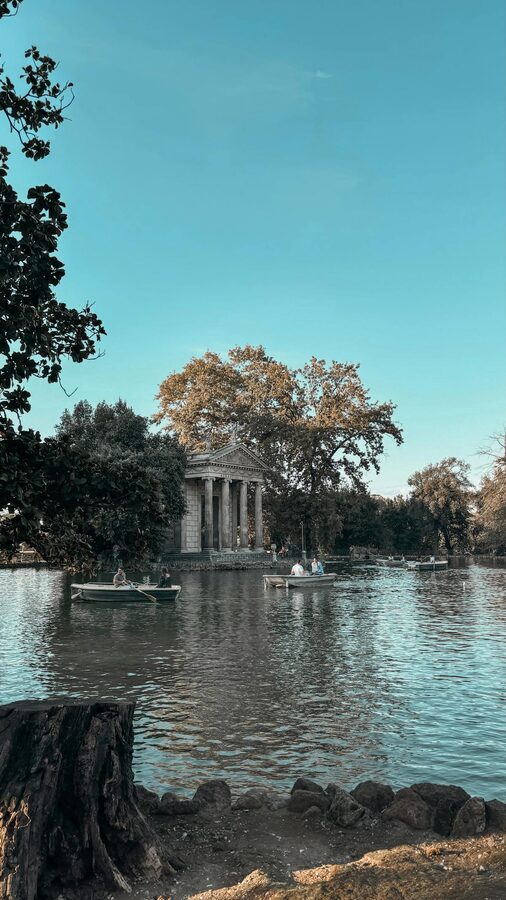 Boaters on the lake near the Temple of Aesculapius in Villa Borghese gardens Rome