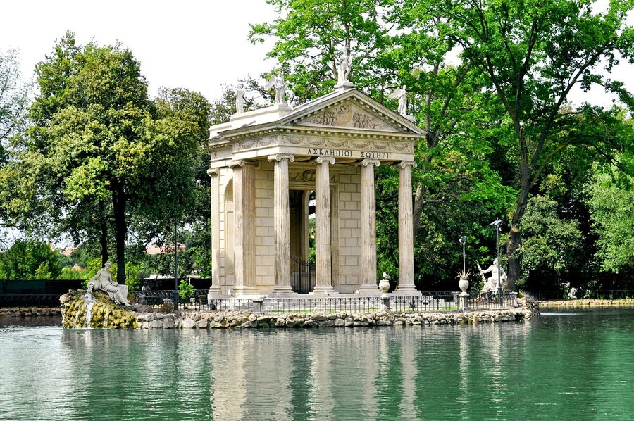 Panoramic view of Villa Borghese park in Rome with green lawns and mature trees