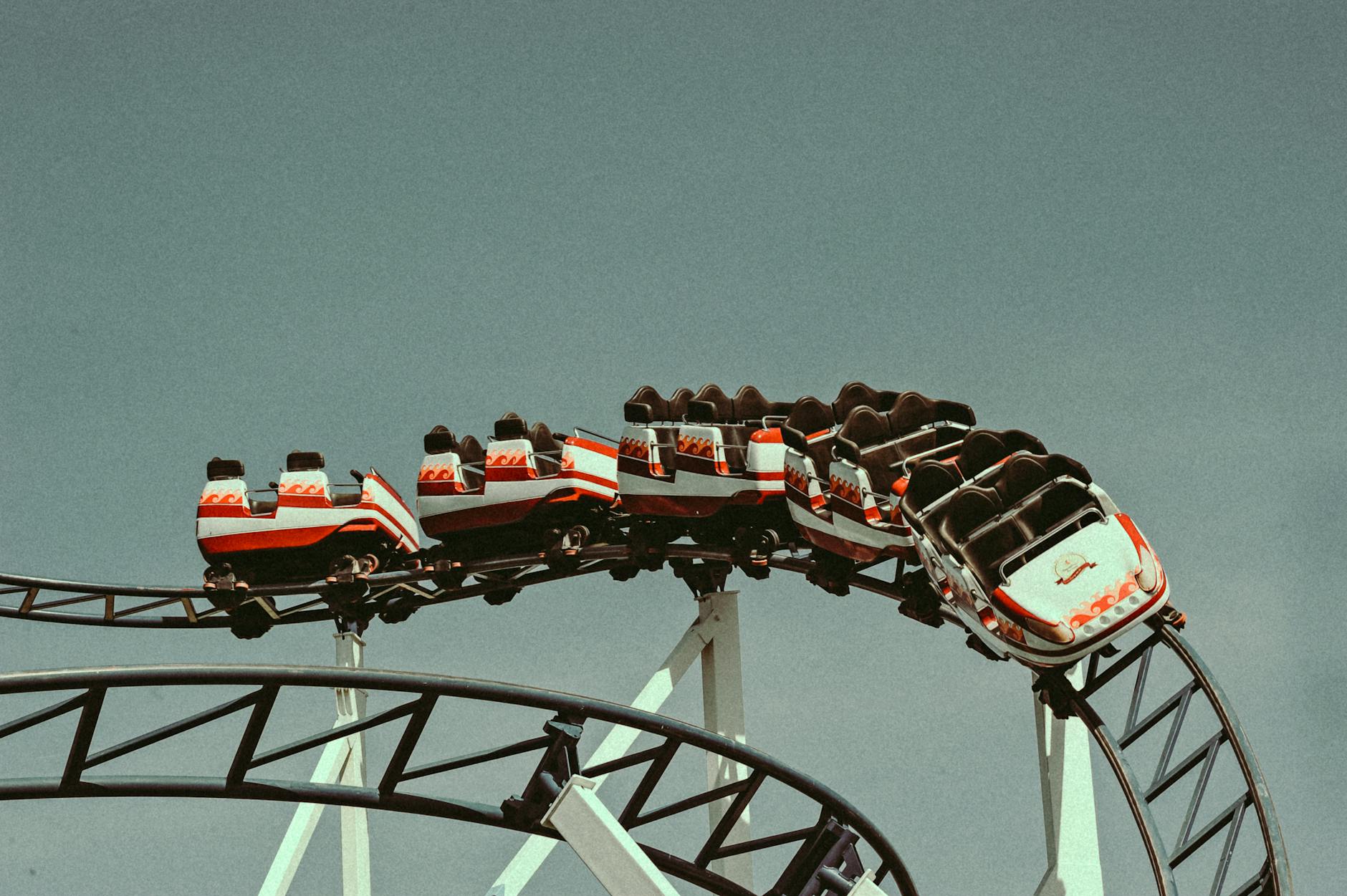 Roller coaster with vintage cars against clear sky
