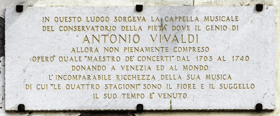 Stone plaque commemorating Antonio Vivaldi on the Chiesa della Pieta wall in Venice