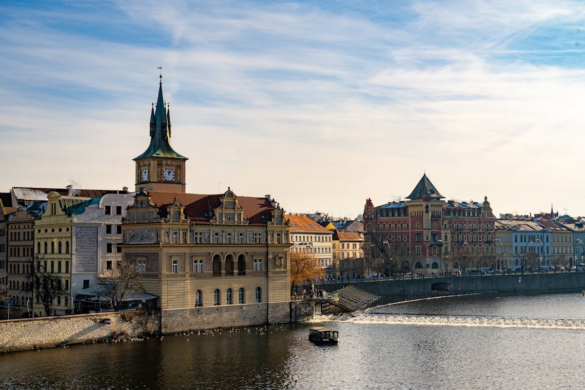Colorful historic buildings lining the Vltava River embankment in central Prague