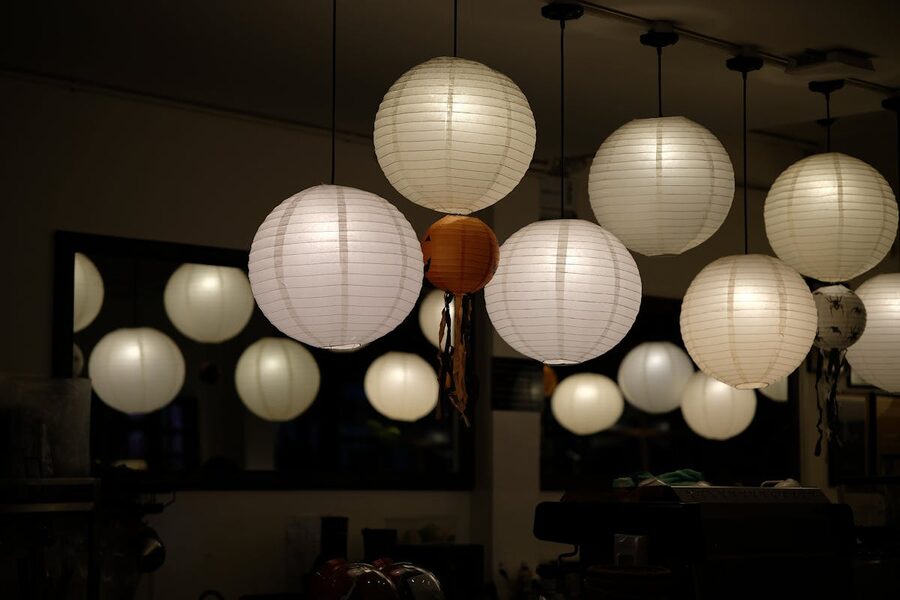 Cozy indoor setting with glowing round paper lanterns creating warm ambient light