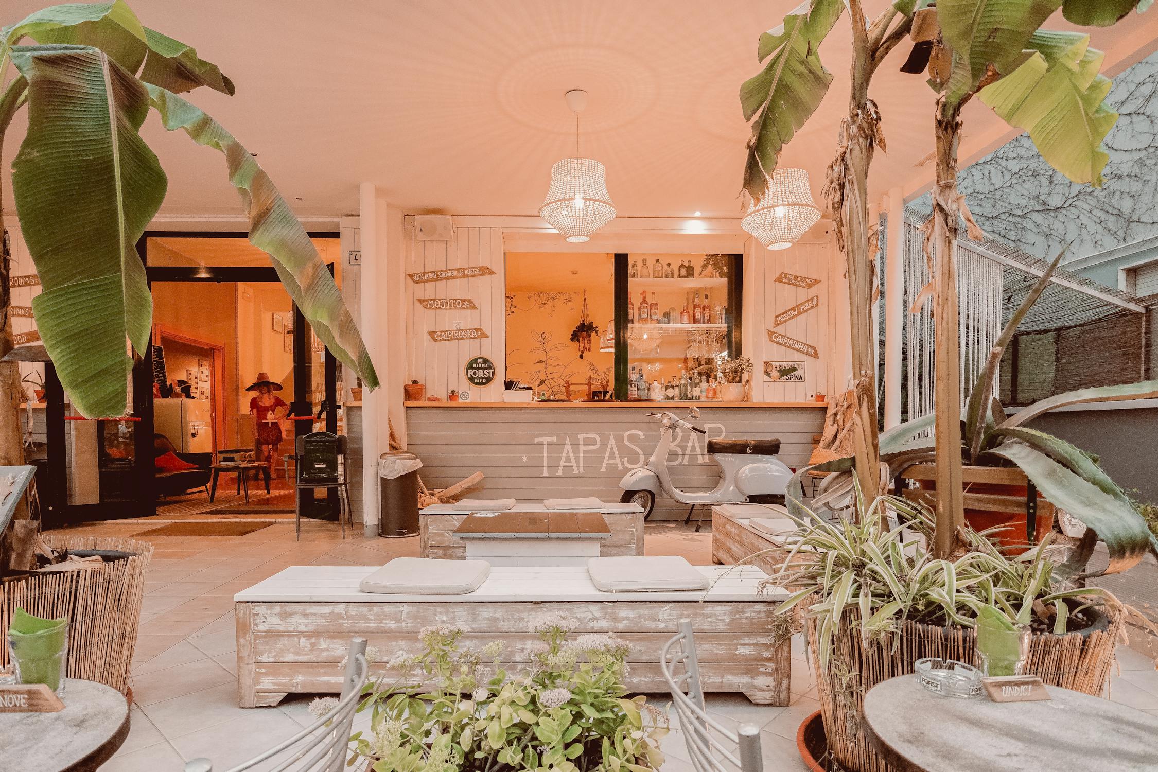 Warmly lit tapas bar interior with wooden furniture and cozy atmosphere