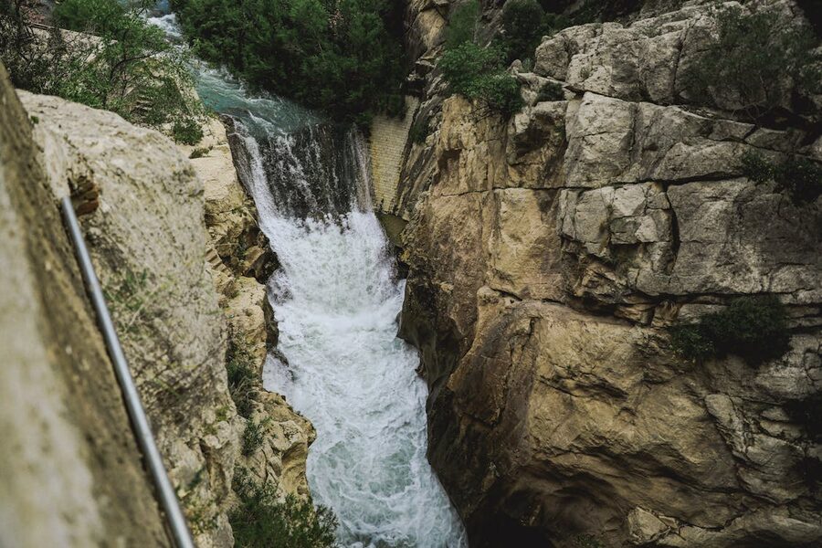 Waterfall cascading through rocky cliffs in Caminito del Rey Spain