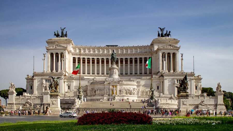 The grand white marble Vittoriano monument in Piazza Venezia Rome with Italian flags flying
