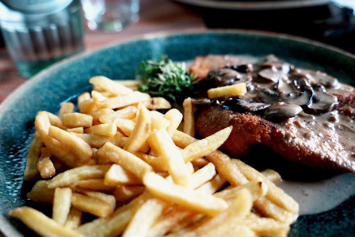 Appetizing Wiener Schnitzel plated with sauce