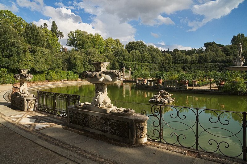 The Isolotto pond and island in Boboli Gardens with classical statues surrounded by water and greenery