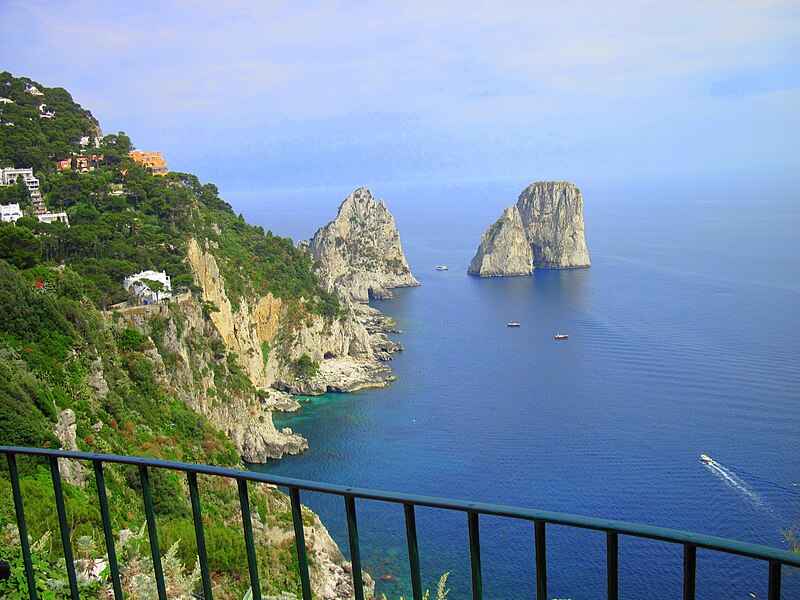 The three Faraglioni rock formations rising from the sea off Capri