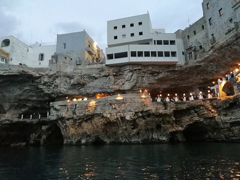 The Grotta Palazzese restaurant balcony as seen from the water with the cave opening visible