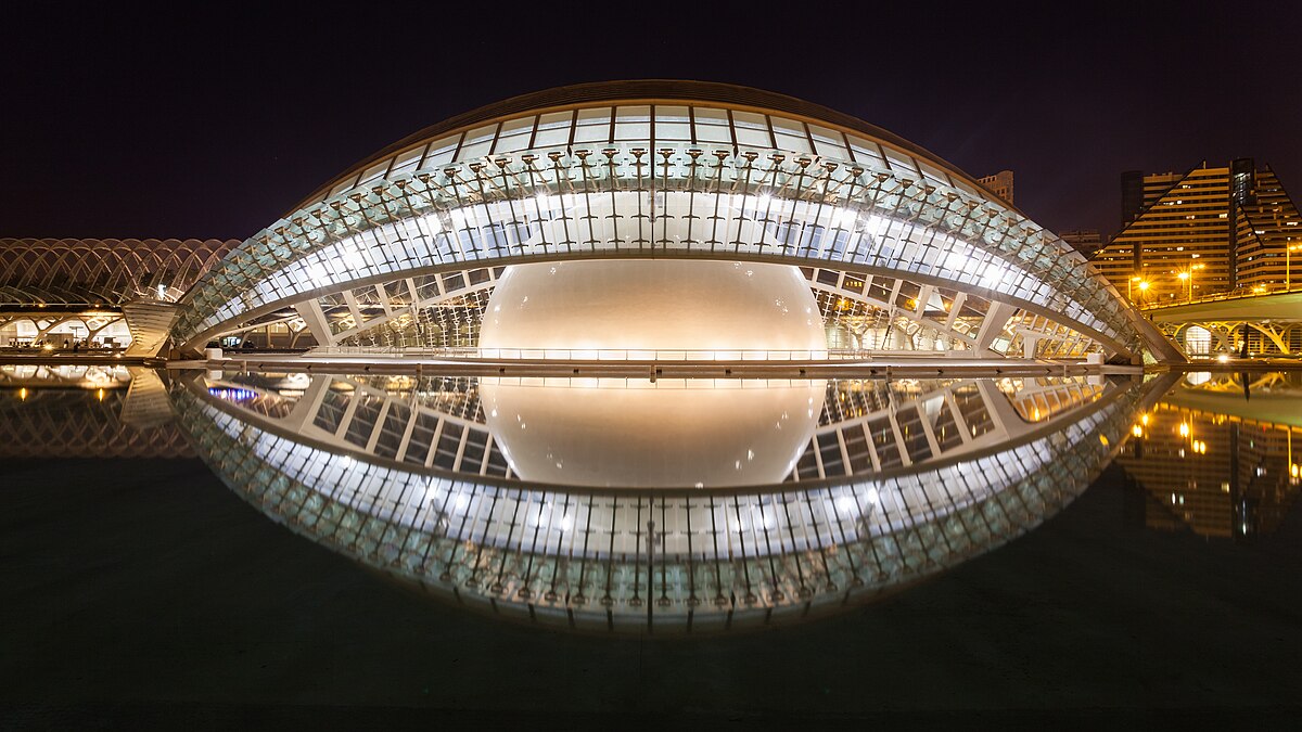 El Hemisferic planetarium building at City of Arts and Sciences Valencia reflected in surrounding pools