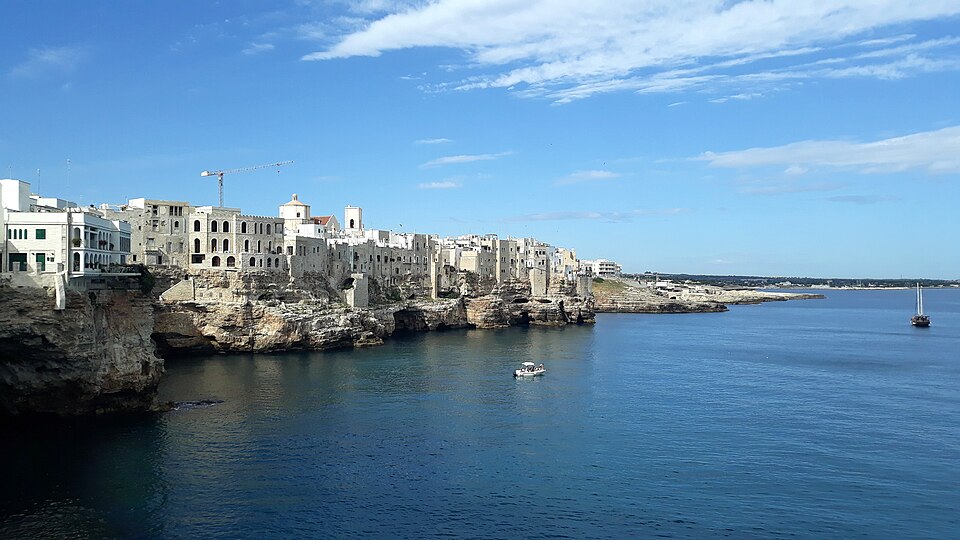 Panoramic view of Polignano a Mare showing the entire town perched on cliff edges above the Adriatic