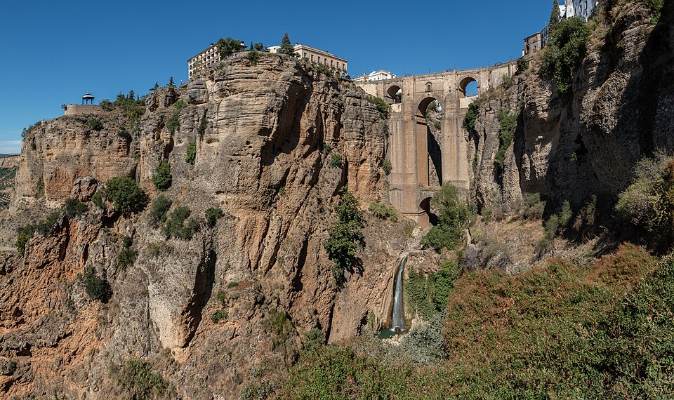 Wide panoramic view of Ronda Spain showing the entire town perched on the clifftop plateau