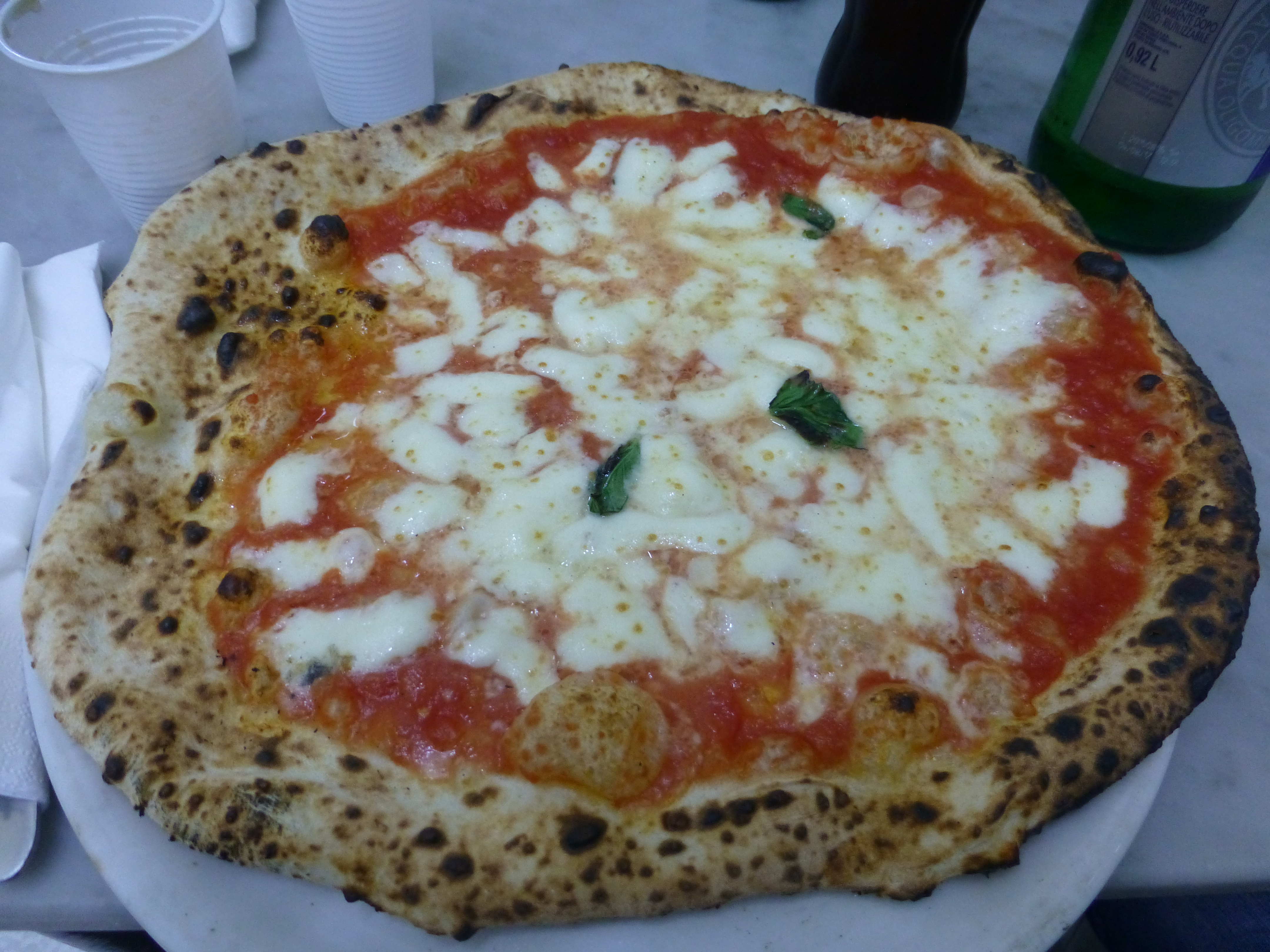 A classic Pizza Margherita served at a traditional pizzeria in Naples, Italy