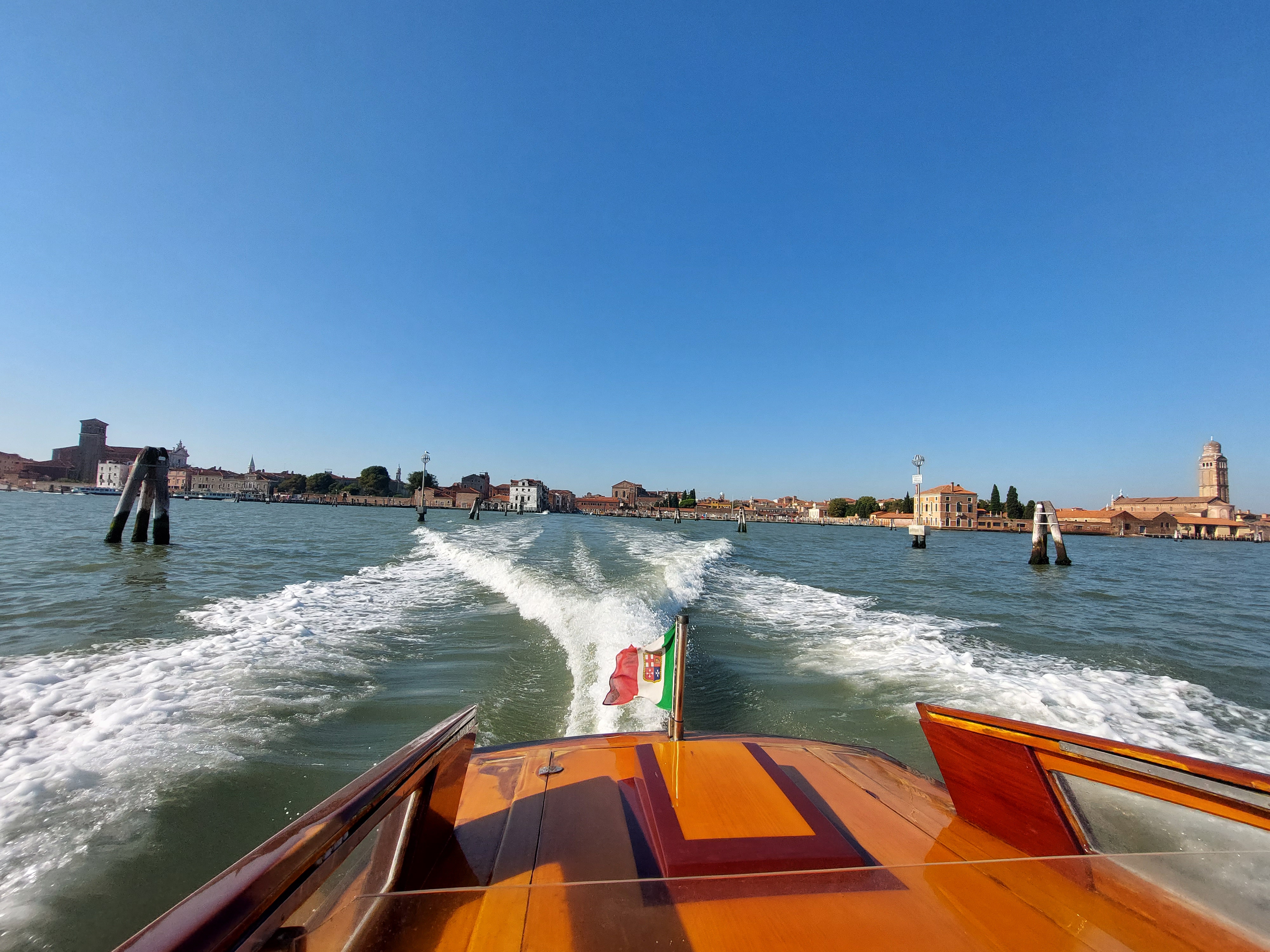 Private speed boat departing Venice heading toward Marco Polo Airport across the lagoon